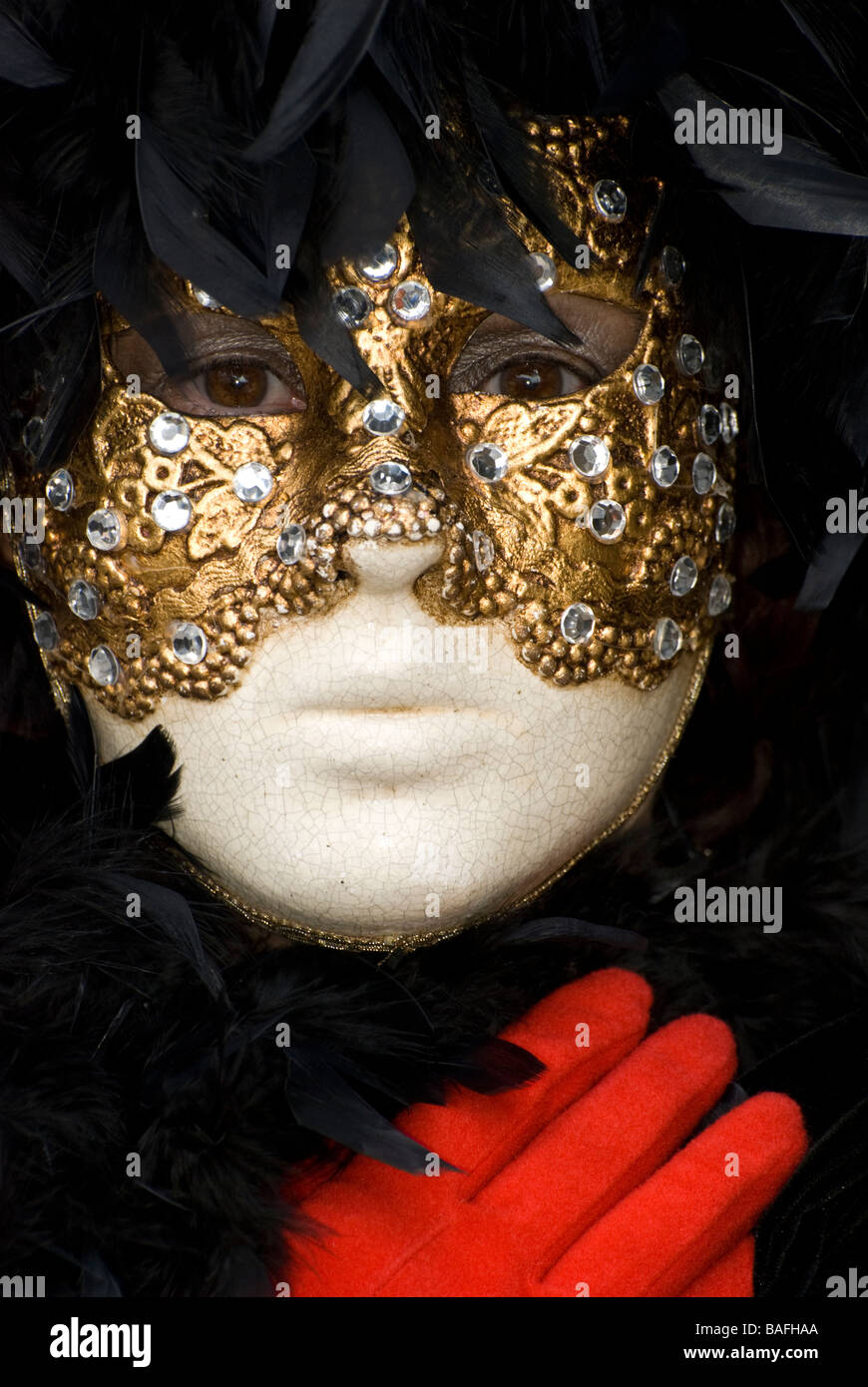 Single girl in a venetian carnival disguise with a gold mask black ...