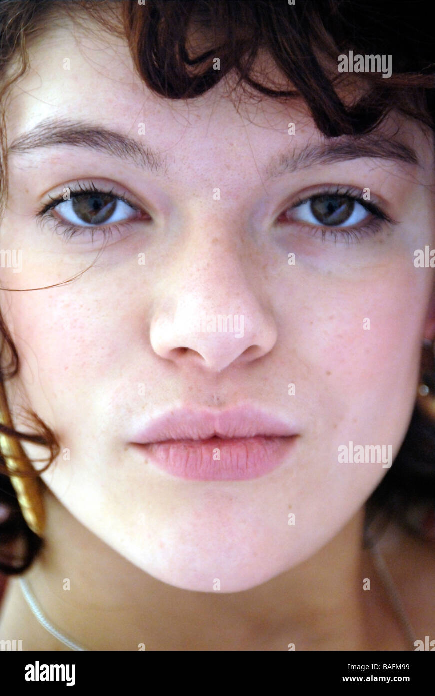 portrait of young girl full face looking forward brown eyes open pink ...