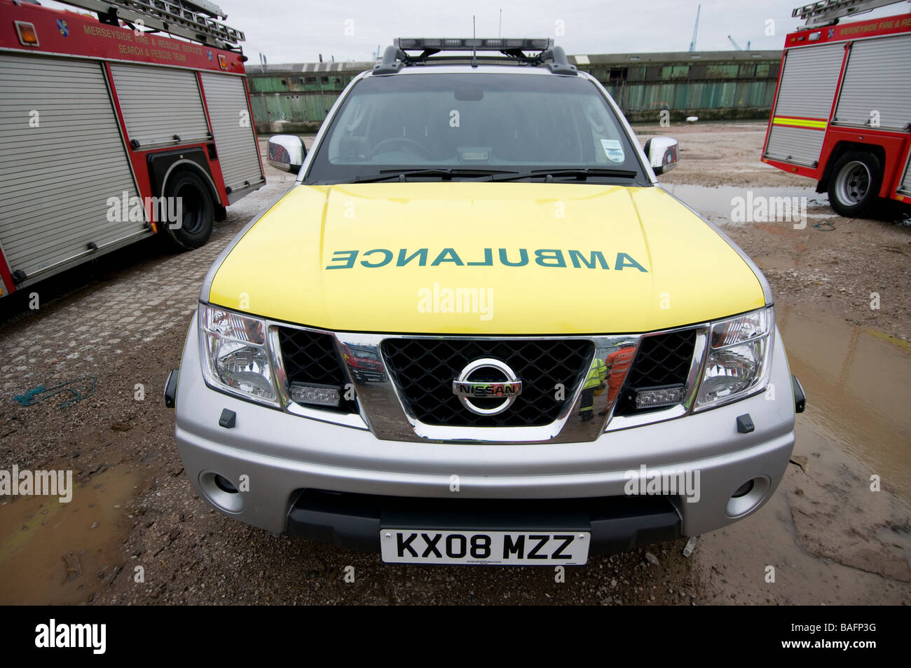 Paramedic ambulance fast response car with fire engines in background ...