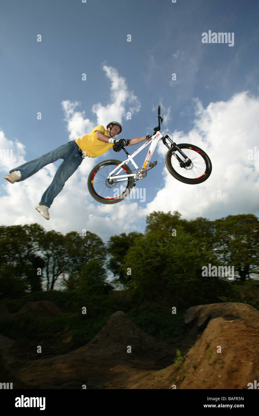 A Mountain Biker performs an amazing no footed jump Stock Photo - Alamy