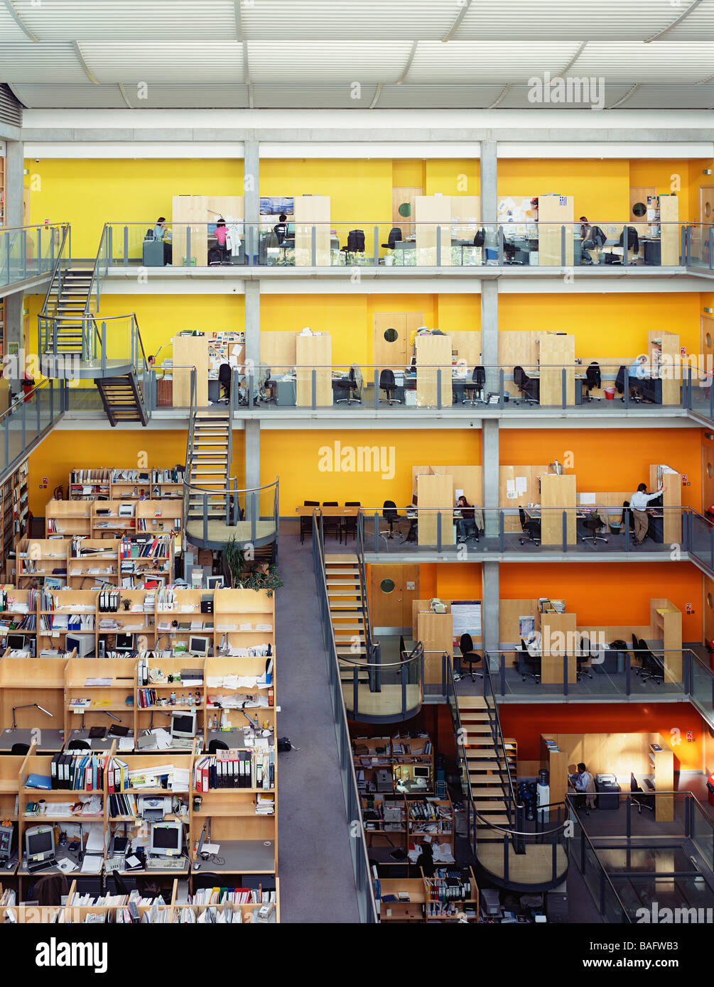 bms building atrium coloured wall with workstations Stock Photo - Alamy
