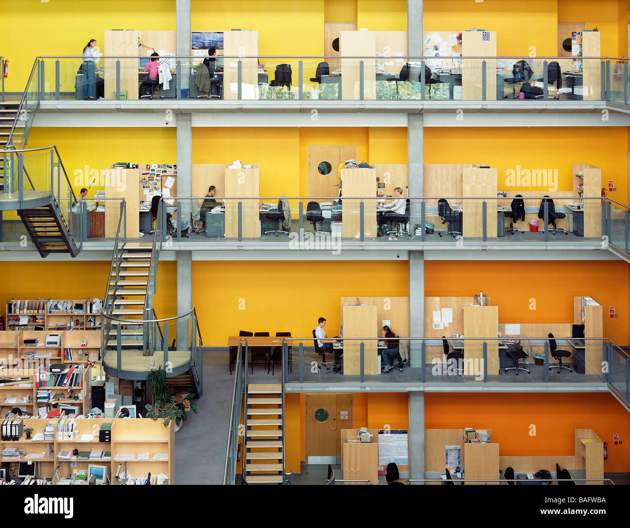 bms building atrium coloured wall with workstations Stock Photo - Alamy