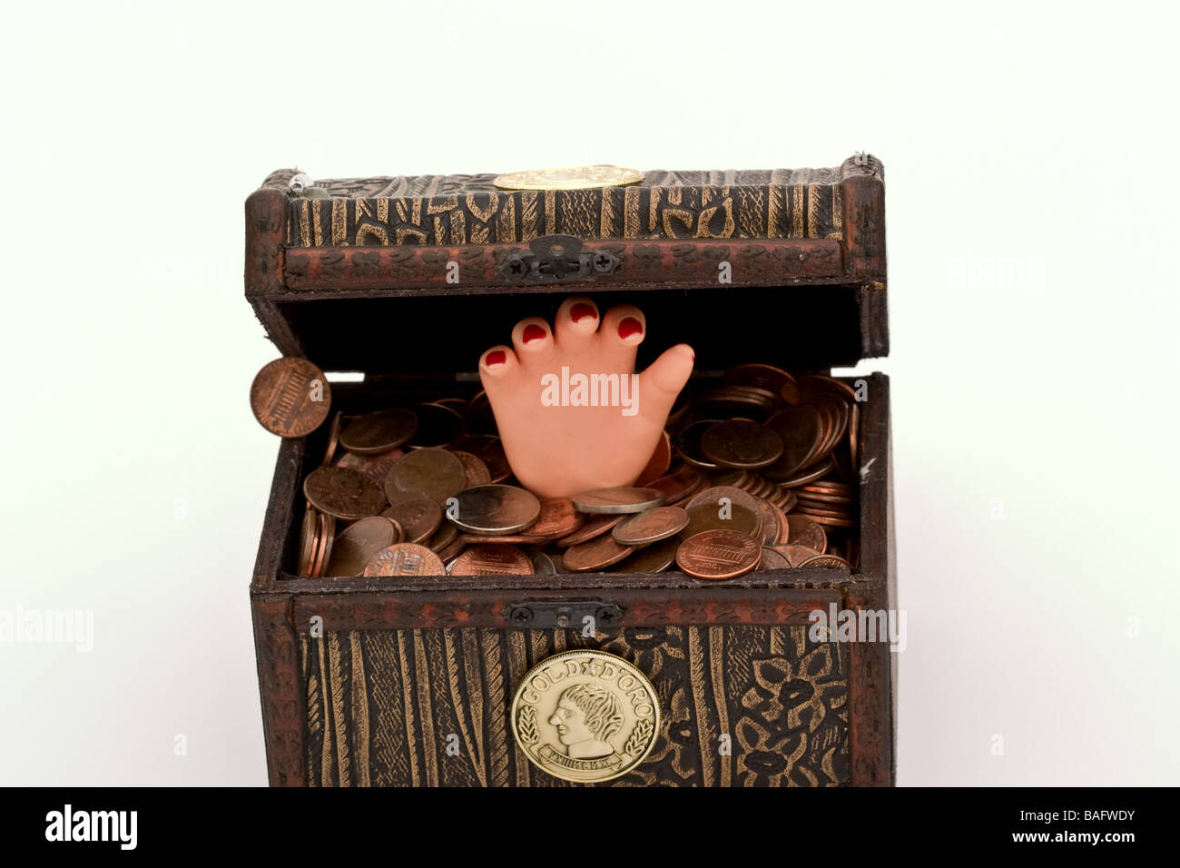 Small plastic hand in a small treasure chest filled with coins Stock ...