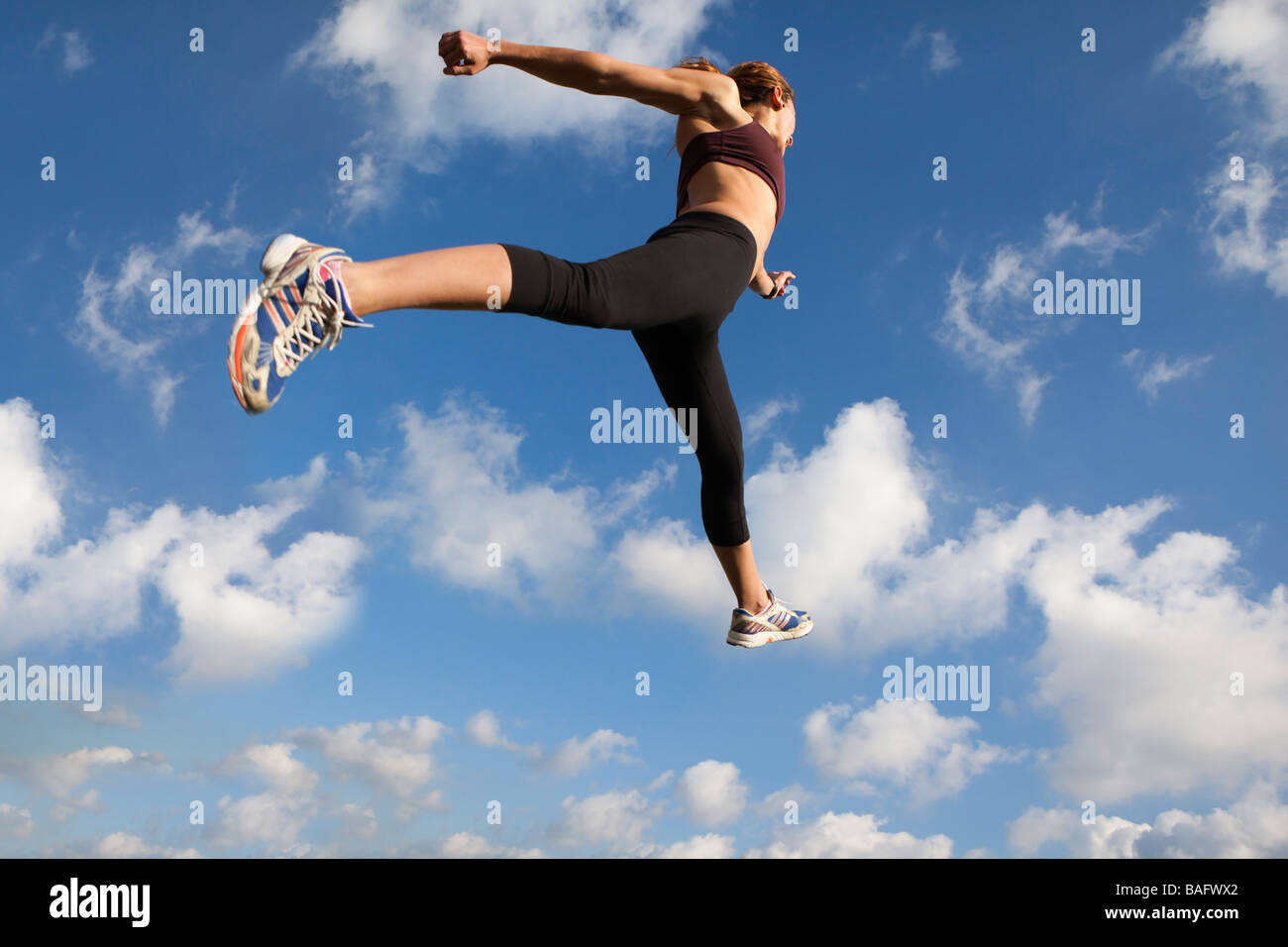 Active woman jumping midair hi-res stock photography and images - Alamy