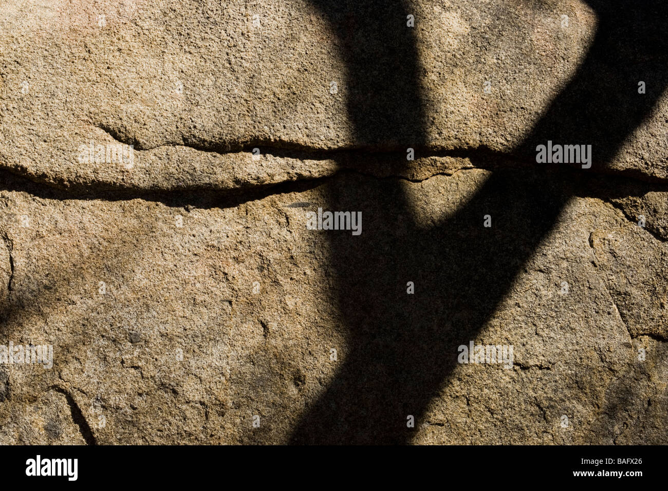 Shadows form on a textured rock wall Stock Photo - Alamy