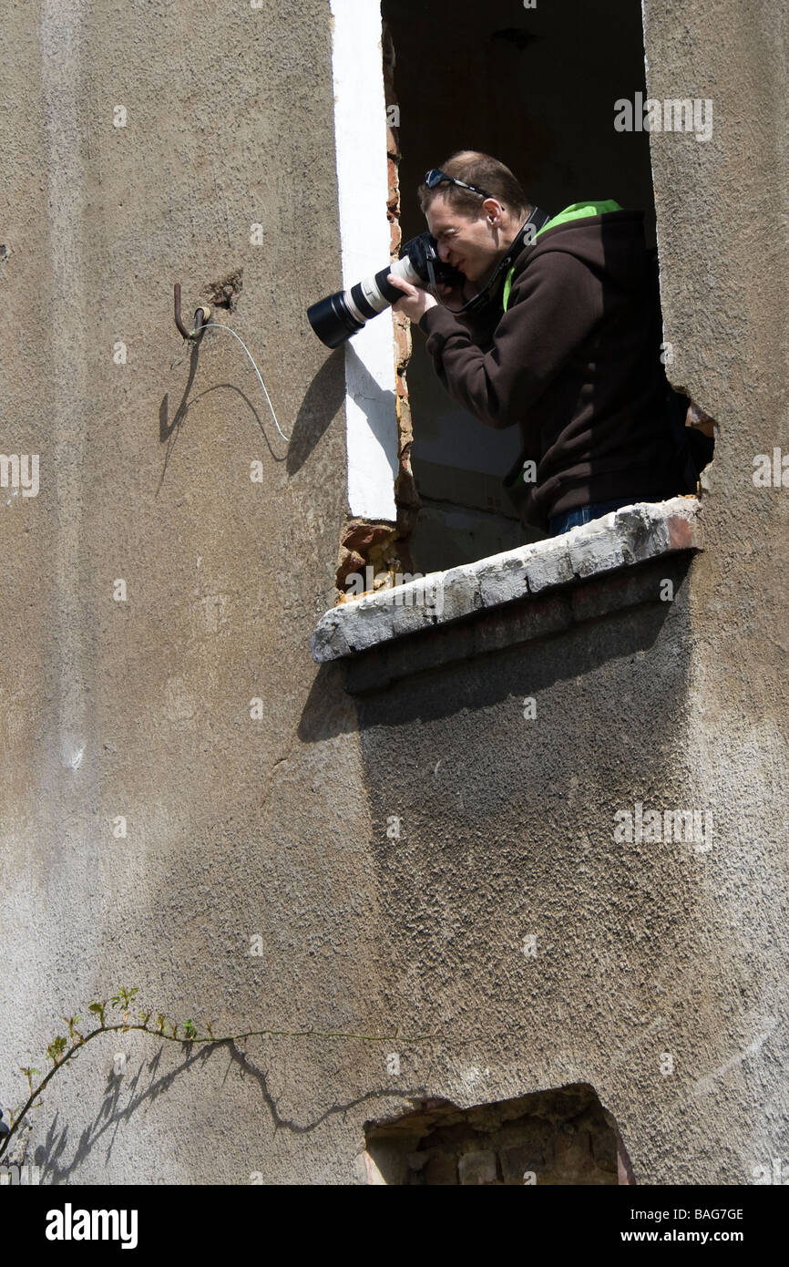 Photographer in a window Stock Photo - Alamy