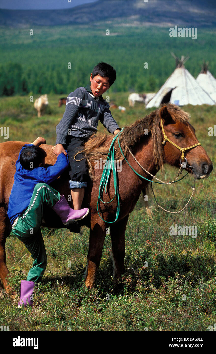 Mongolia, Khovsgol Province, red taiga, Tsaatan boys on horseback Stock ...