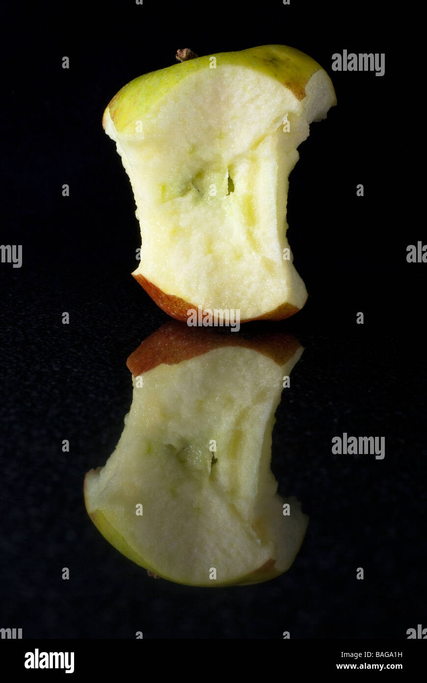 Core of a braeburn apple on a polished black granite surface Stock ...