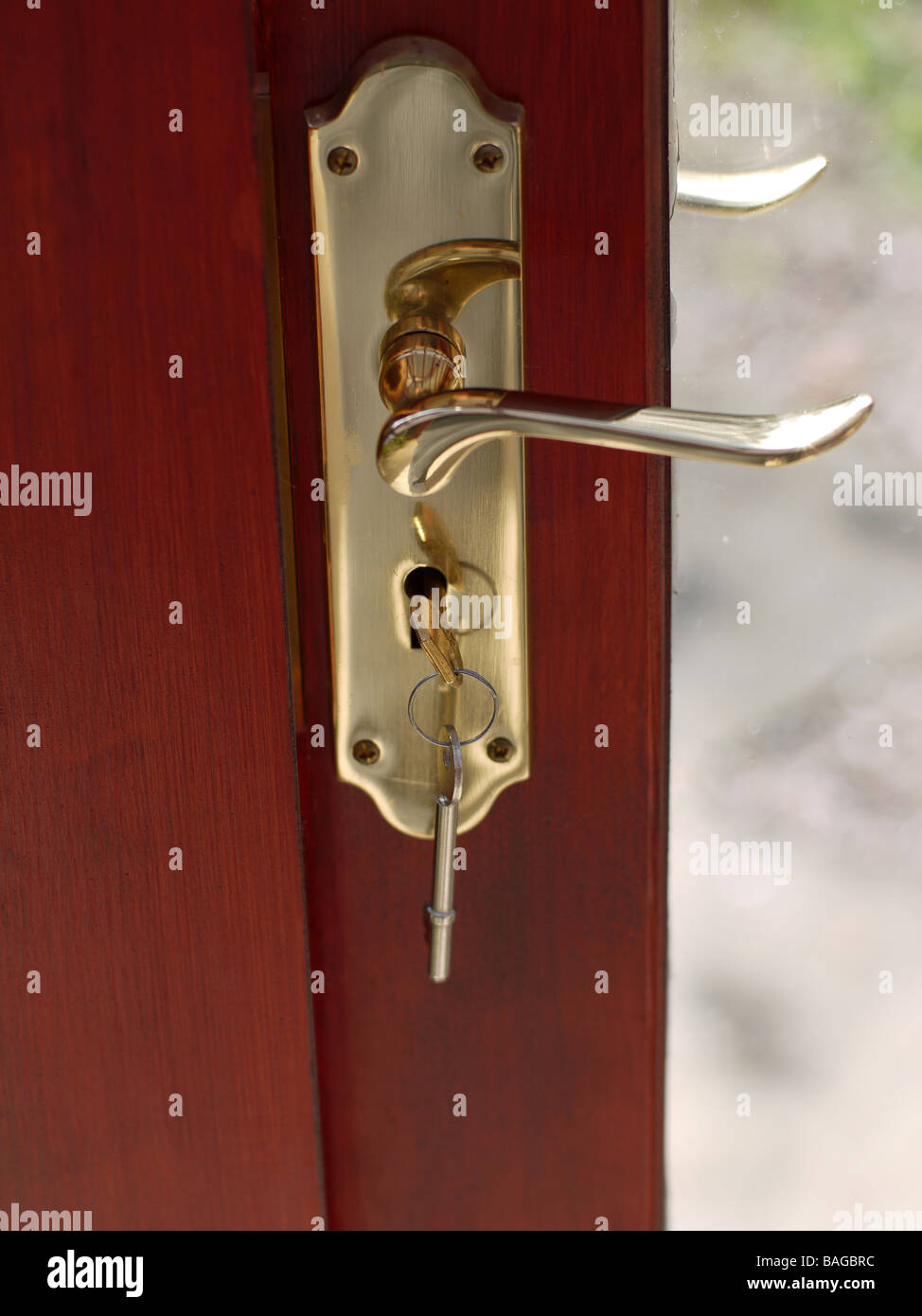 A key in door illustrating security Stock Photo - Alamy