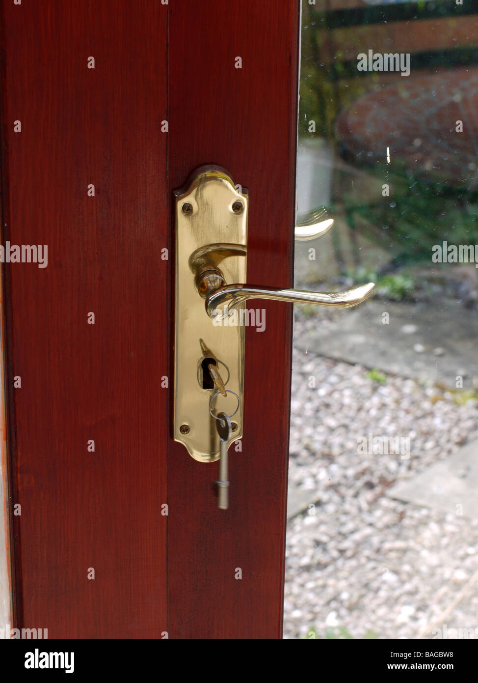 A key in door illustrating security Stock Photo - Alamy