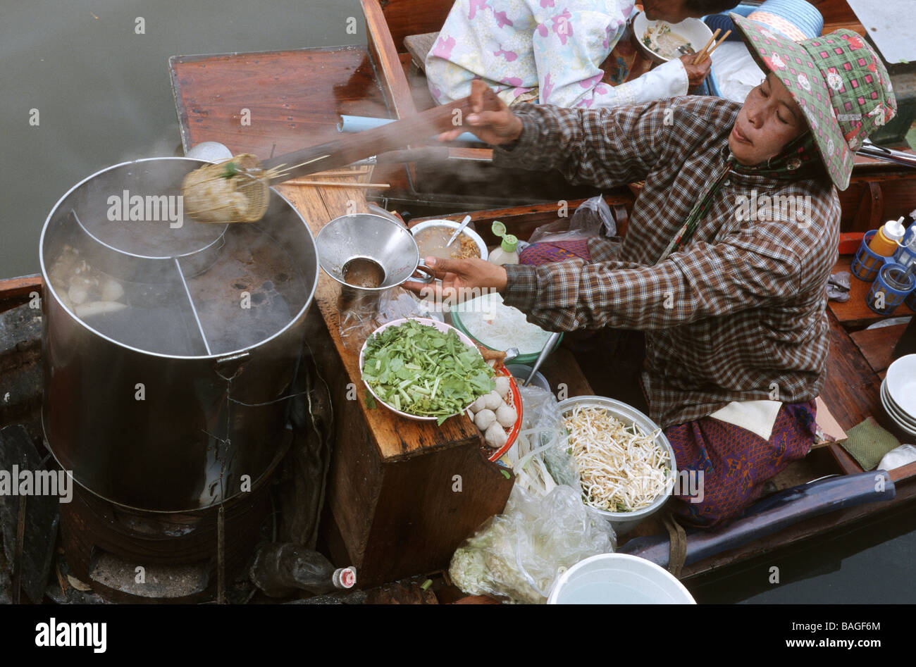 Thailand, Bangkok, merchant soup on his boat, Tha Kha Floating market ...