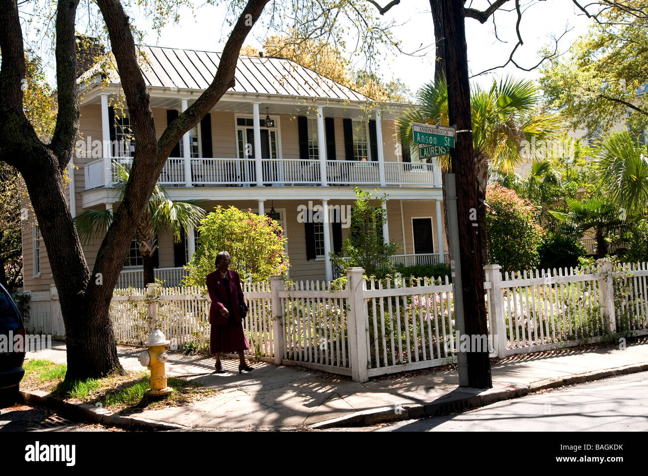 Southern Mansion with teed garden and lady going to church in ...