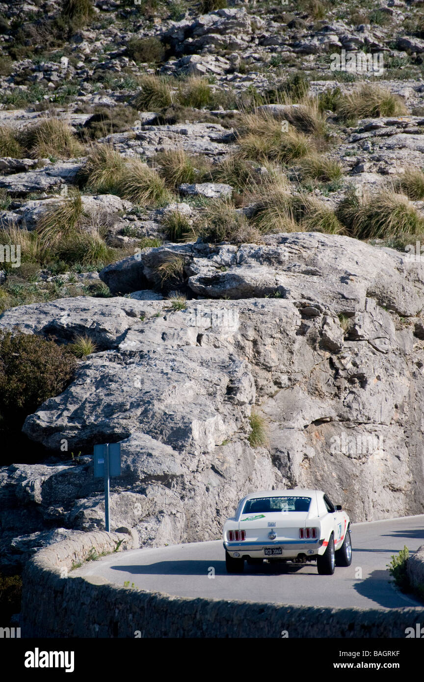 Rear view of a 1969 White Ford Mustang classic sports car racing in the ...