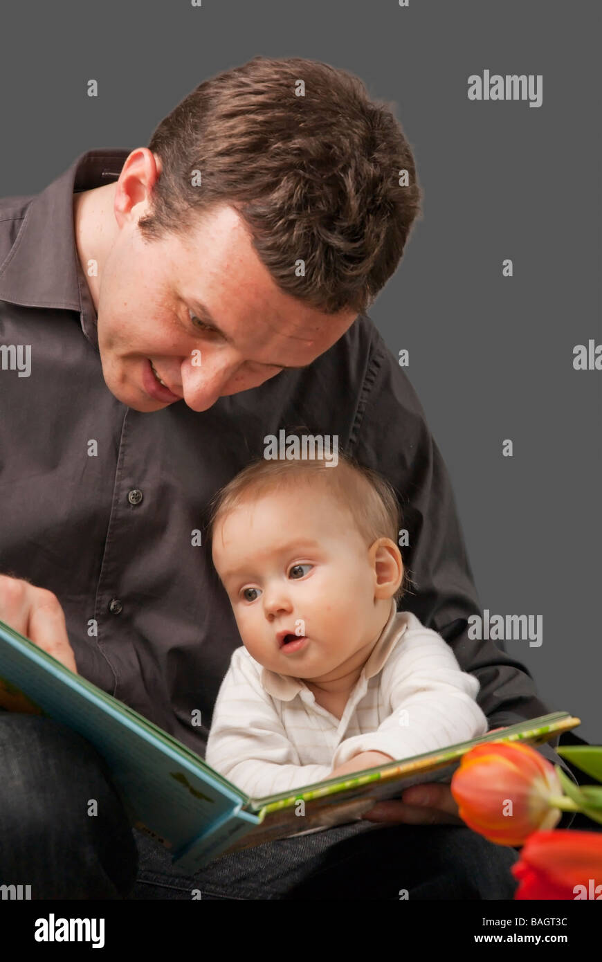 Father reads a book with baby Stock Photo - Alamy