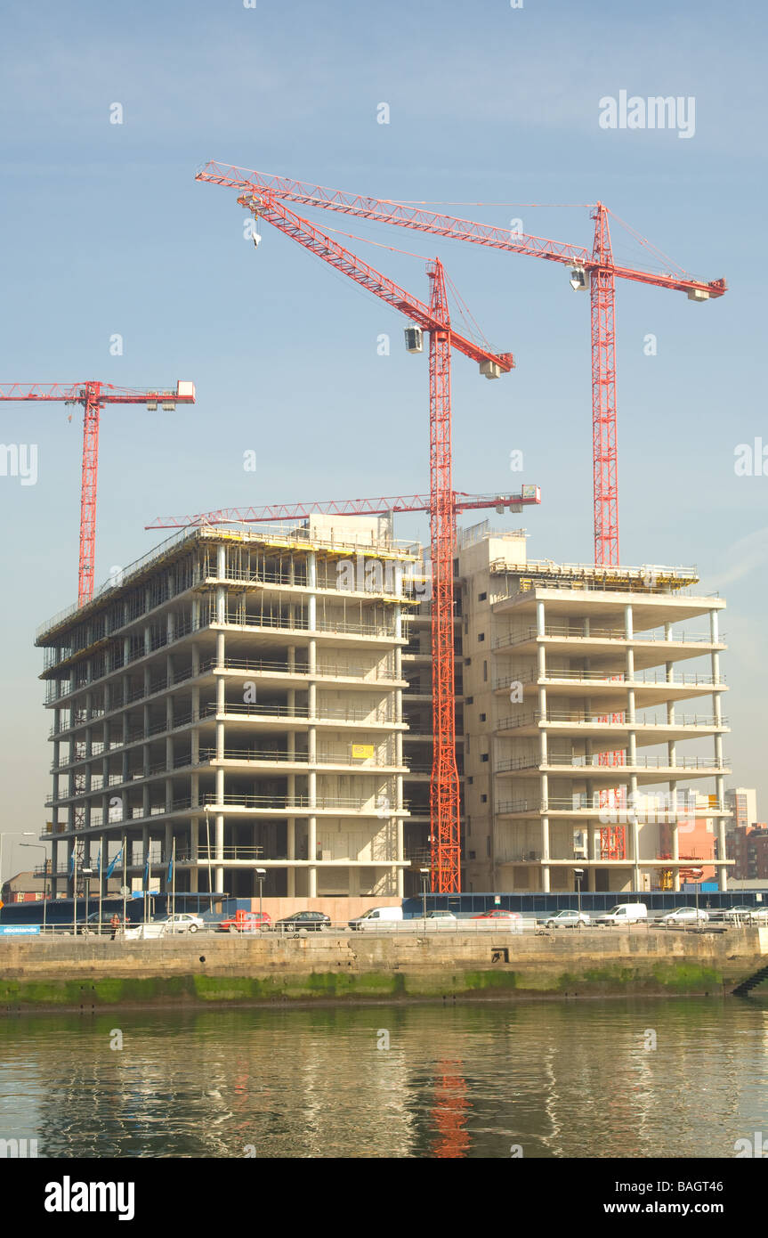 Red construction cranes at high rise development in Dublin on river ...