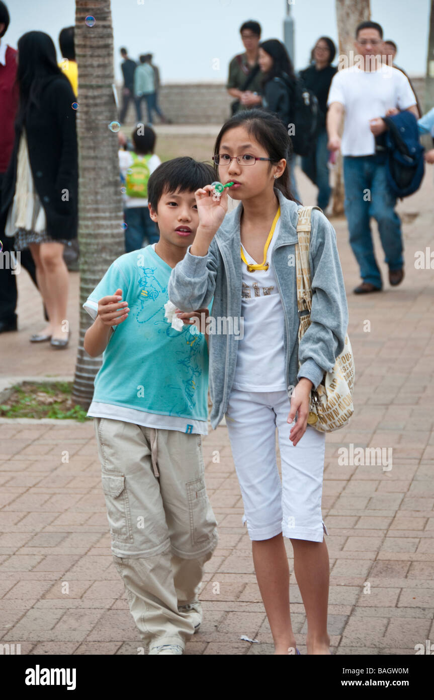 Kids playing with soap bubbles Stock Photo - Alamy