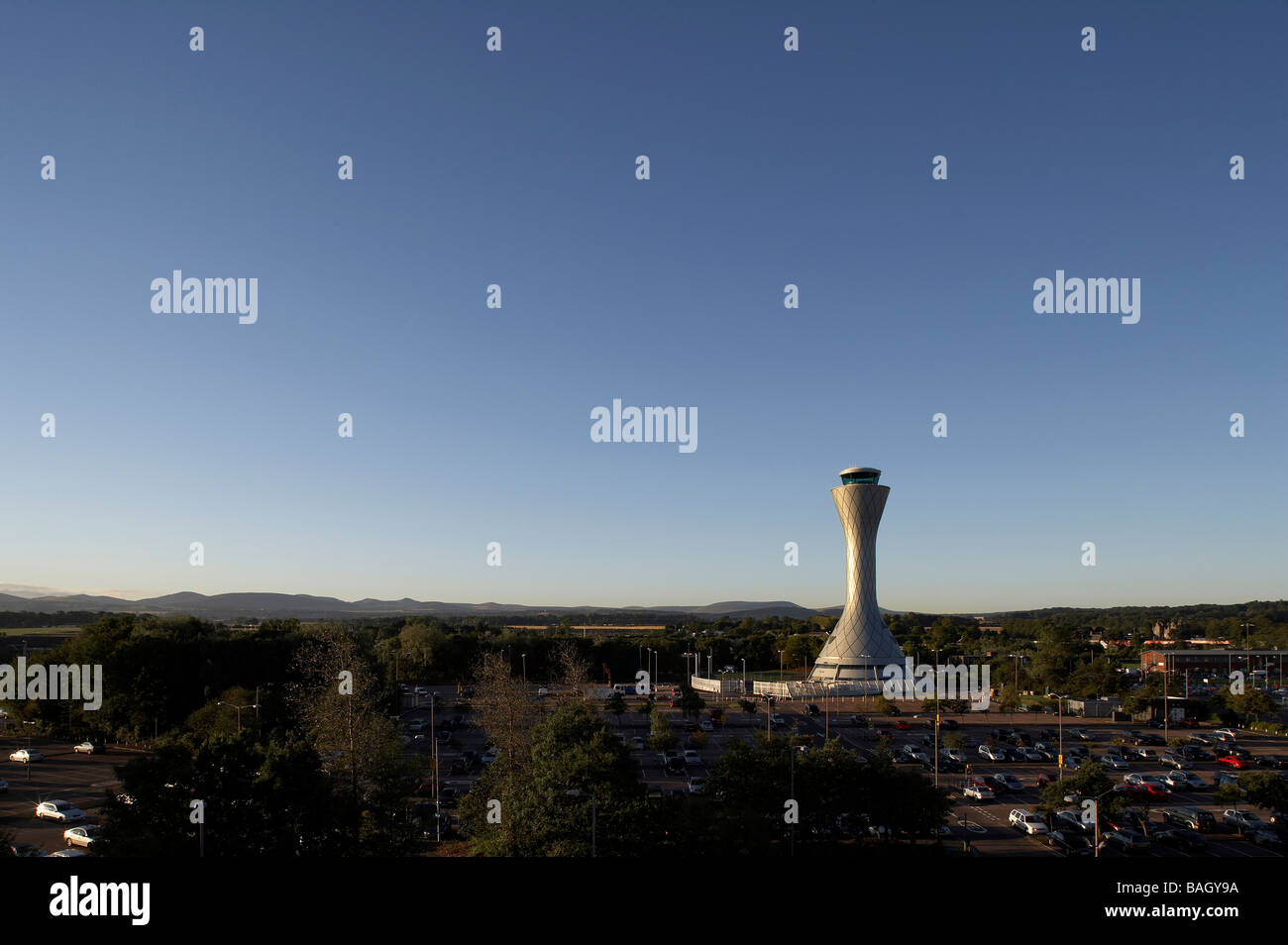 air traffic control tower view from car park to tower and mountains ...