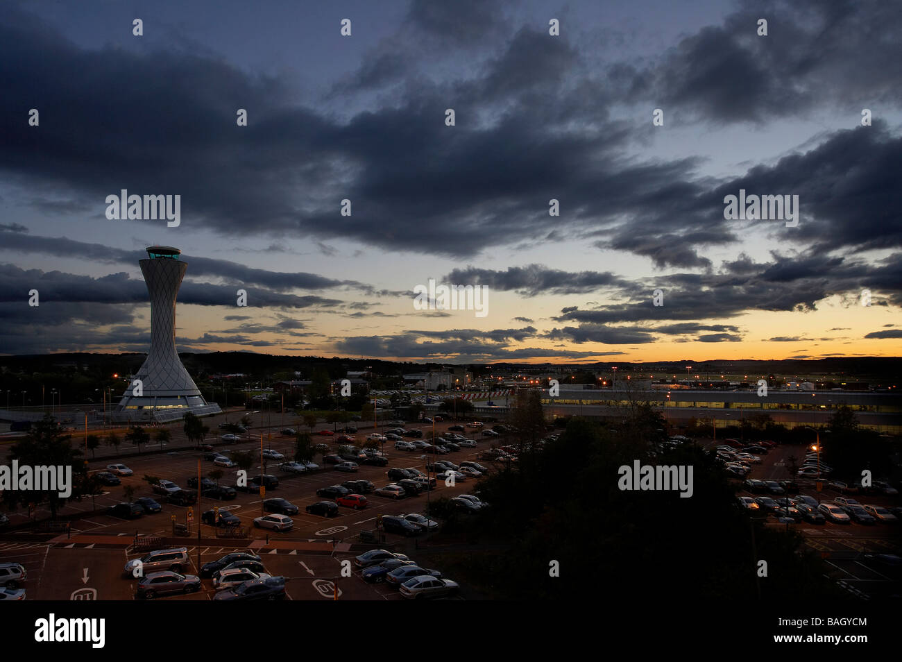 air traffic control tower sunset view with moving clouds across car ...
