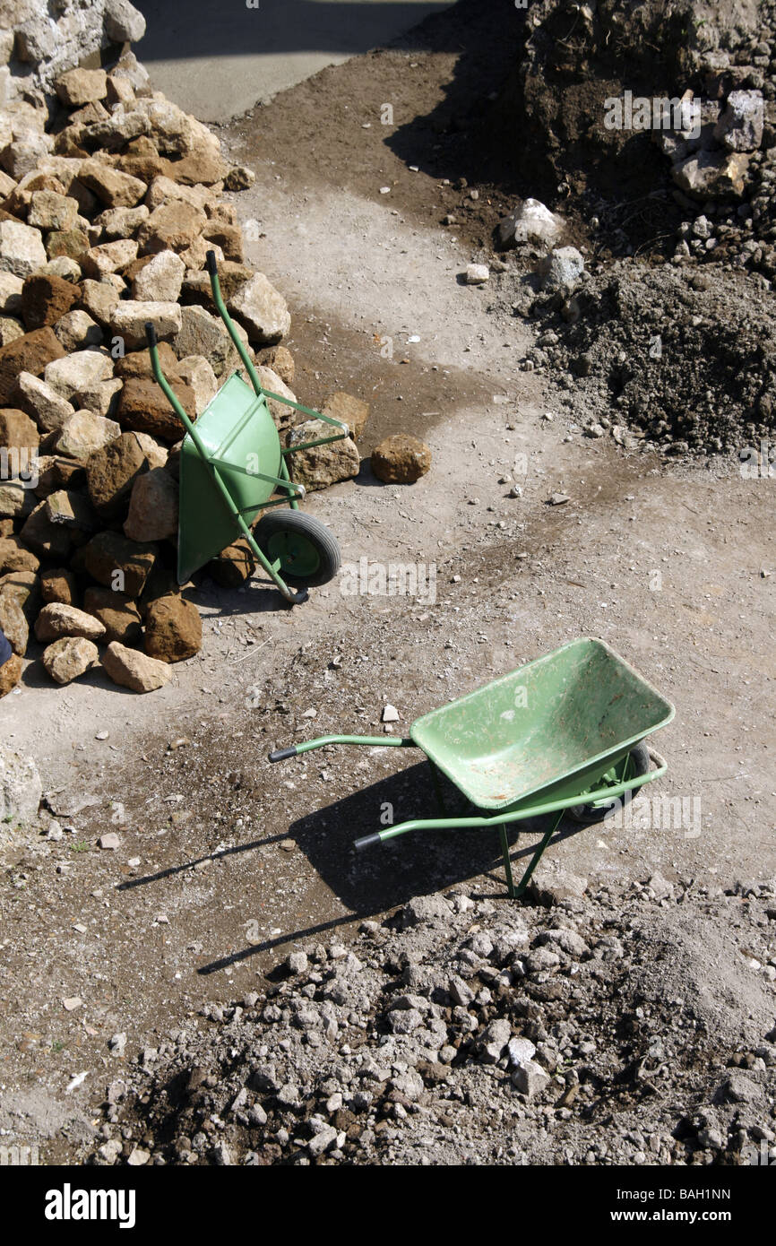 two green wheelbarrows at archaeological site in sun Stock Photo - Alamy