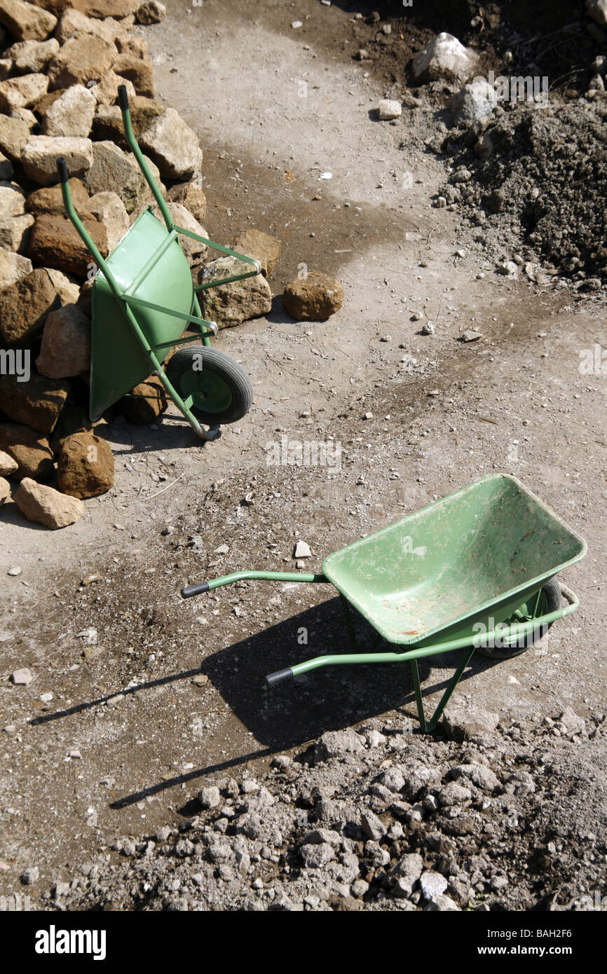 two green wheelbarrows at archaeological site in sun Stock Photo - Alamy