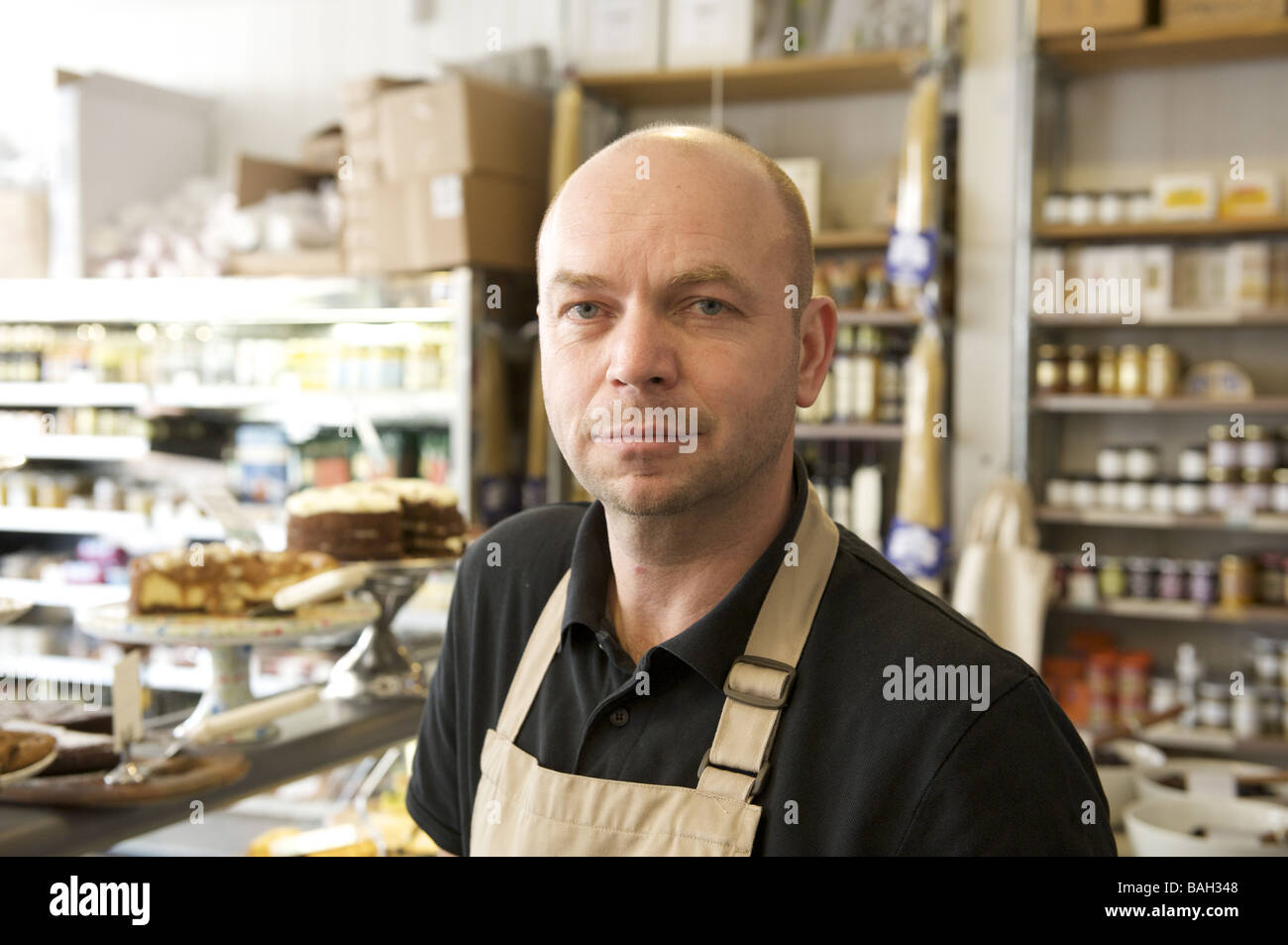 Male shopkeeper with apron Stock Photo - Alamy