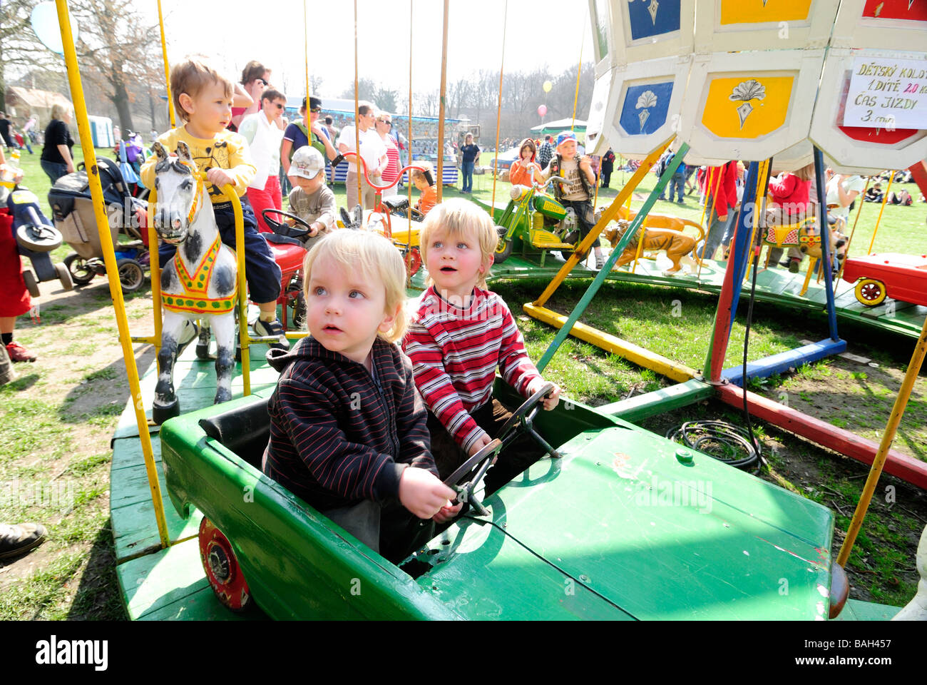 Blond child children 2 years boy boys kids on a carousel Czech Republic ...
