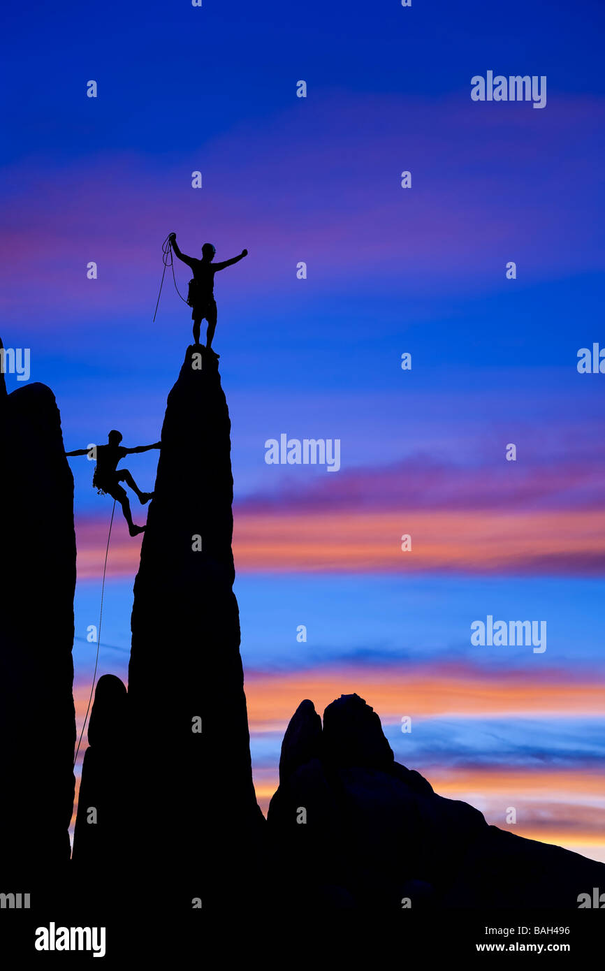 Team of rock climbers nearing the summit Stock Photo - Alamy