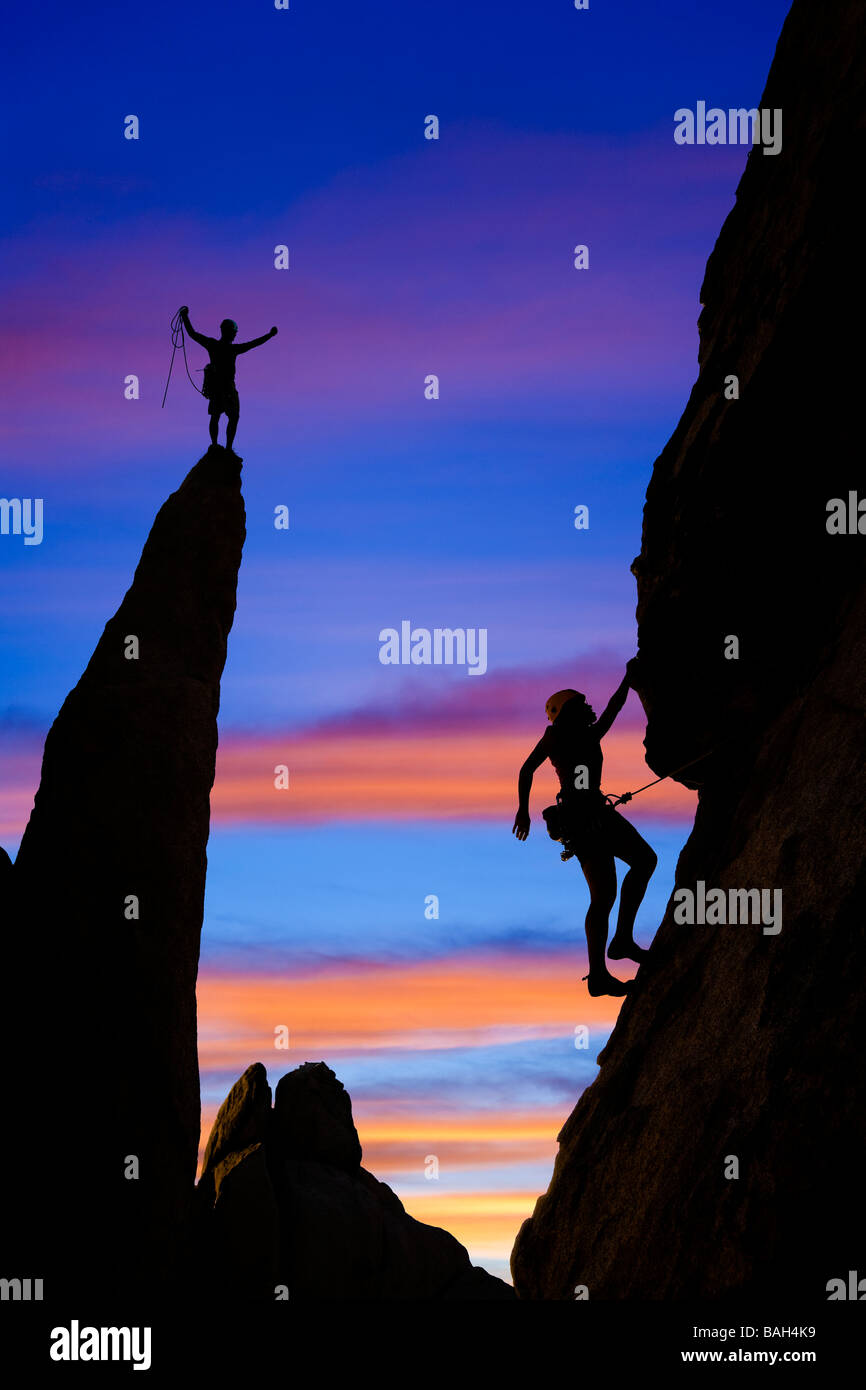 Team of rock climbers nearing the summit Stock Photo - Alamy