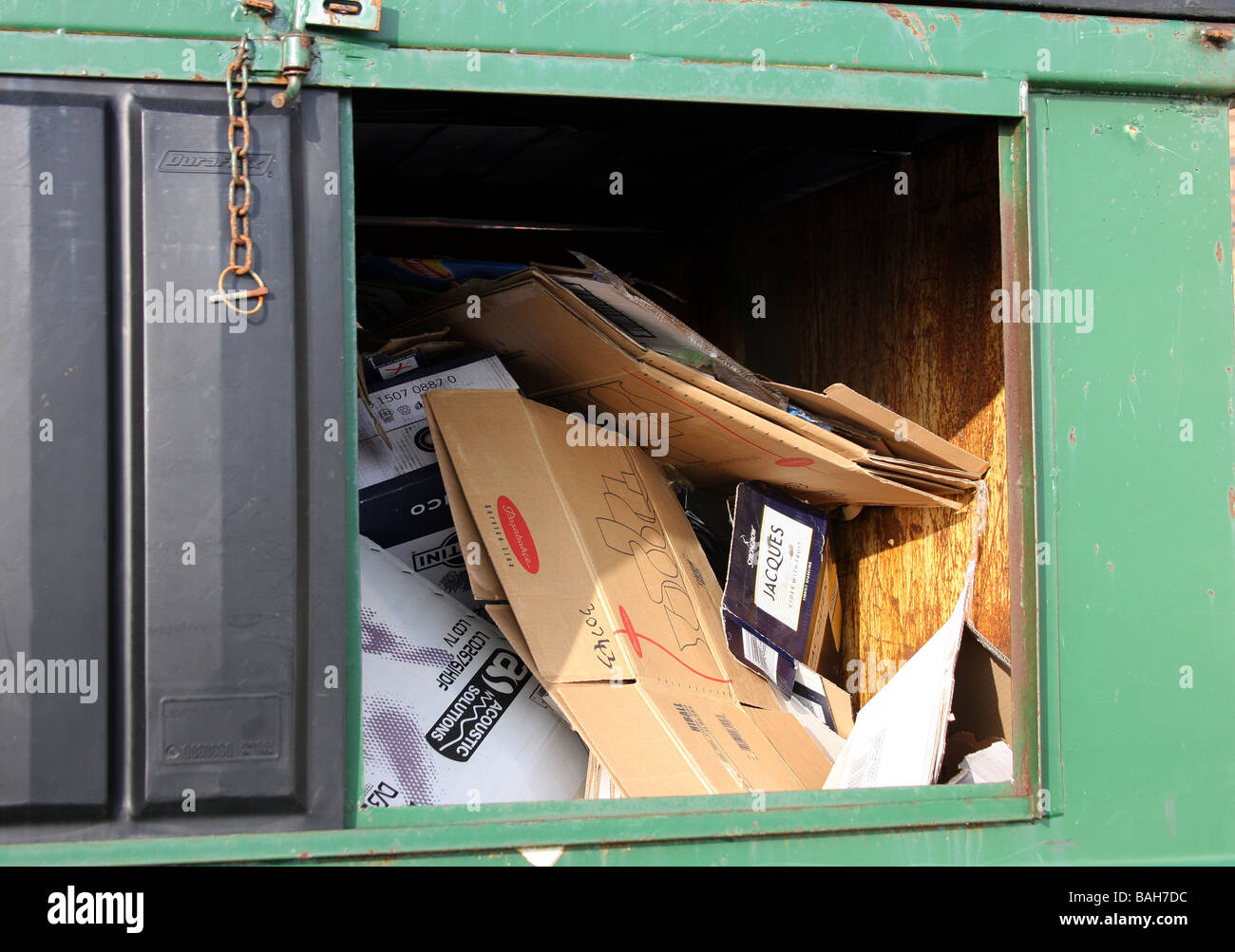 Cardboard dumped into recycling skip Stock Photo - Alamy