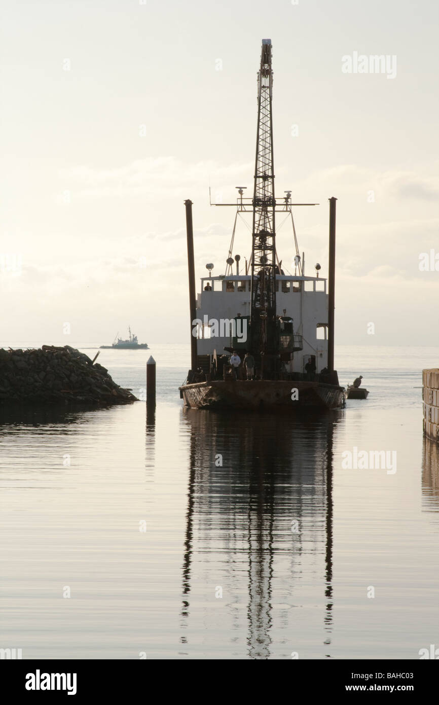 A salvage barge enters the harbor Stock Photo - Alamy