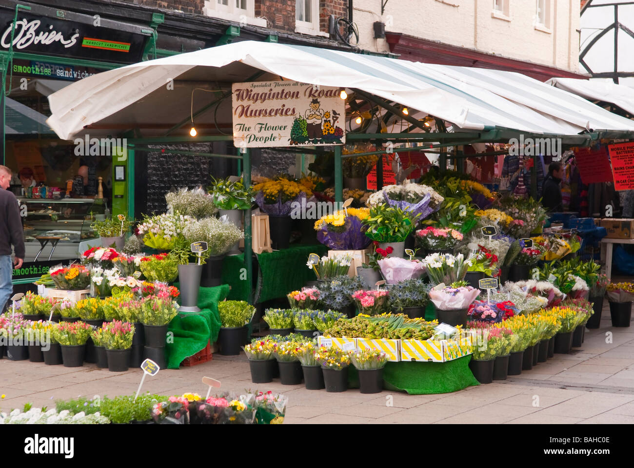 An outdoor market stall florists shop store selling fresh flowers in ...