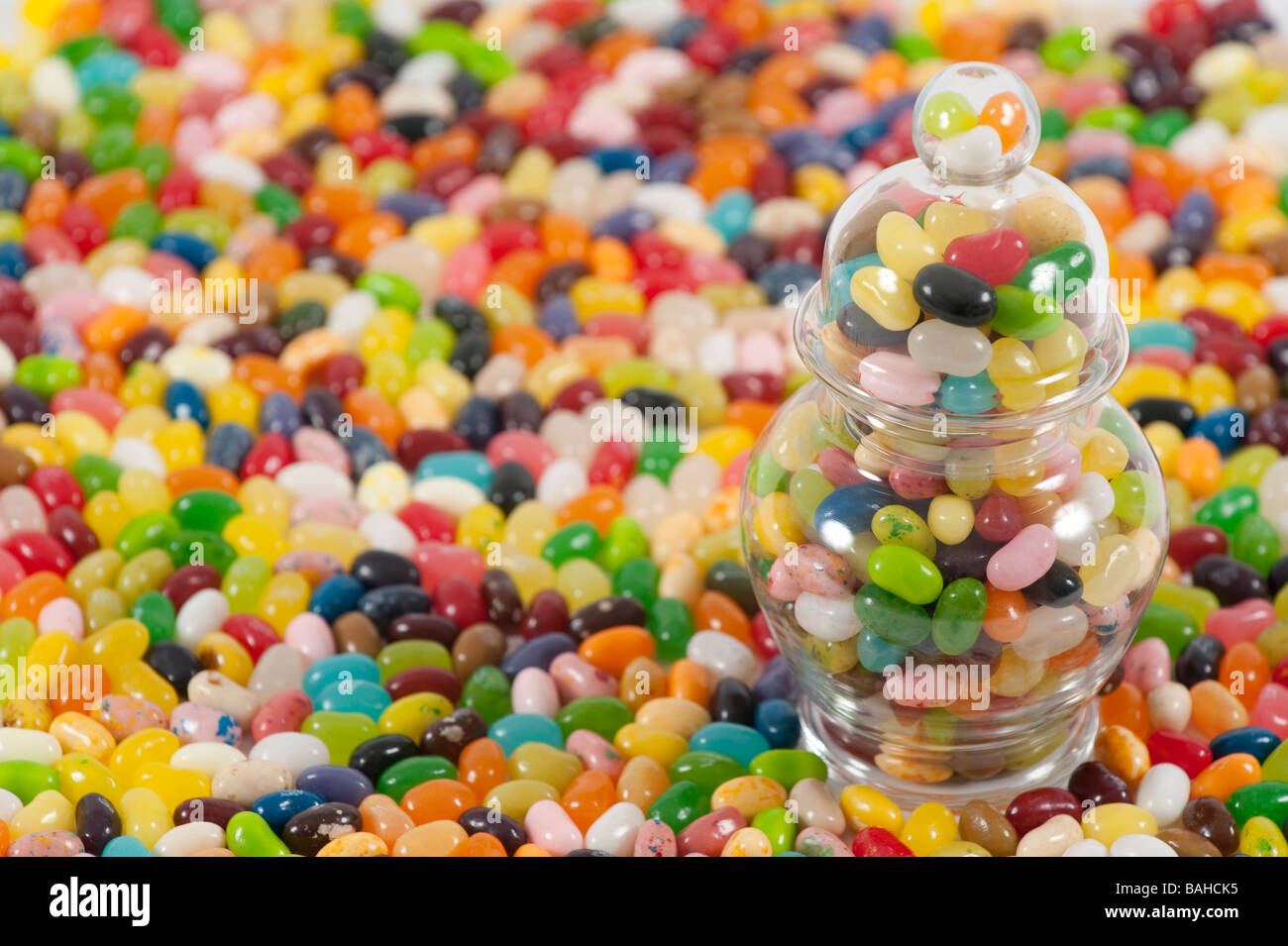 Jellybeans around a jar full of jellybeans Stock Photo - Alamy