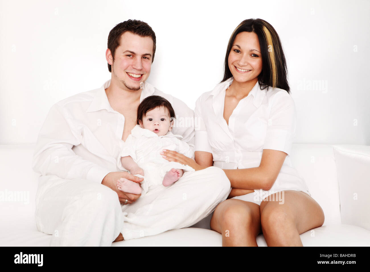 A young happy family with their 4 month old son Stock Photo - Alamy