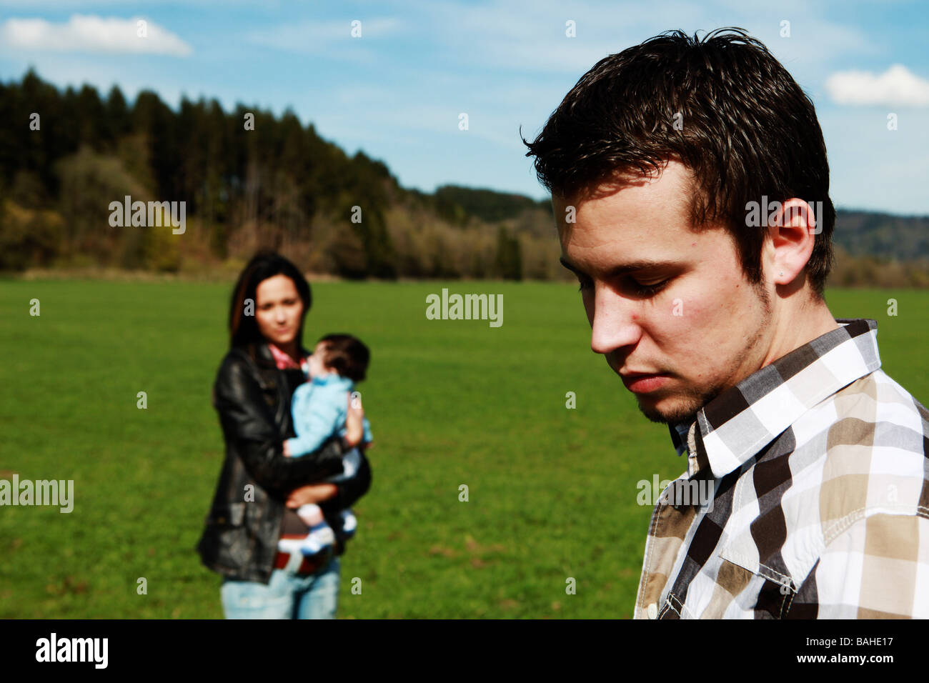 sad man standing aside from woman with baby divorce Stock Photo - Alamy