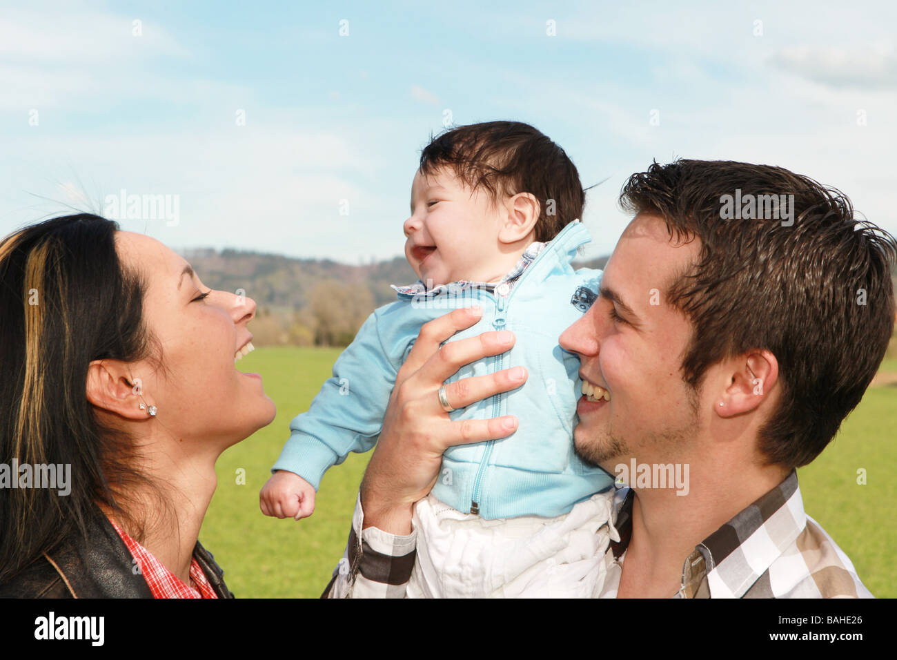 A young happy family with their 4 month old son Stock Photo - Alamy