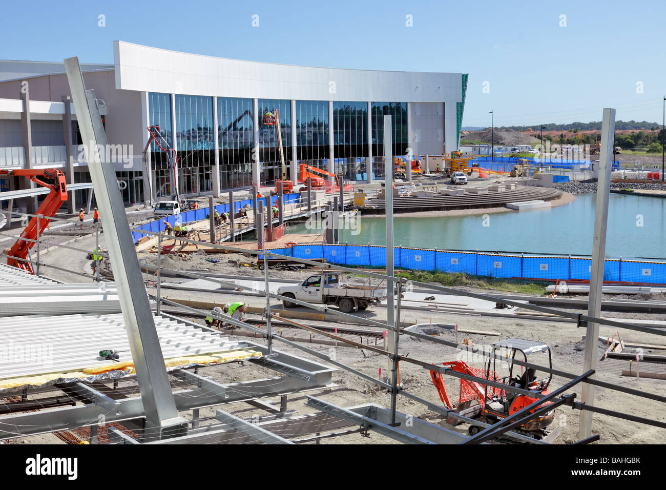 Construction of a new facility by a man made lake Stock Photo - Alamy