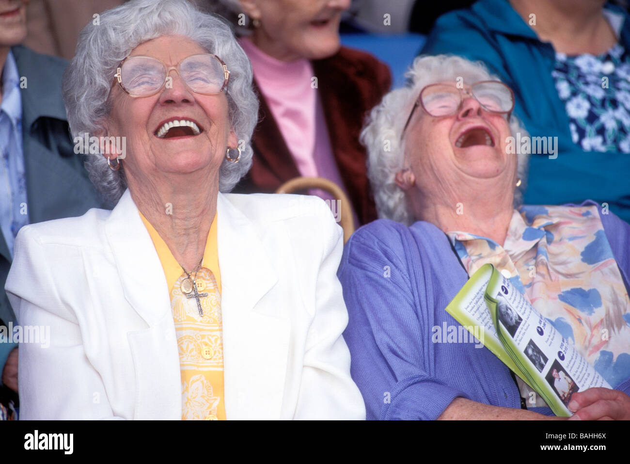 2 elderly ladies laughing at a pensioners event, Southwark, southeast ...