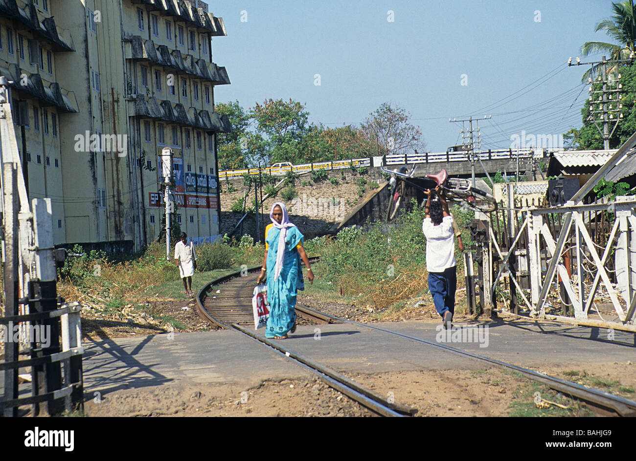 Kollam, Quilon, India, people walking on the railway track passing ...