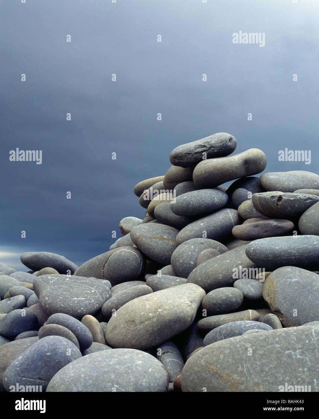 Stacked pebbles at the seaside under a grey sky. Westward Ho! Pebble ...