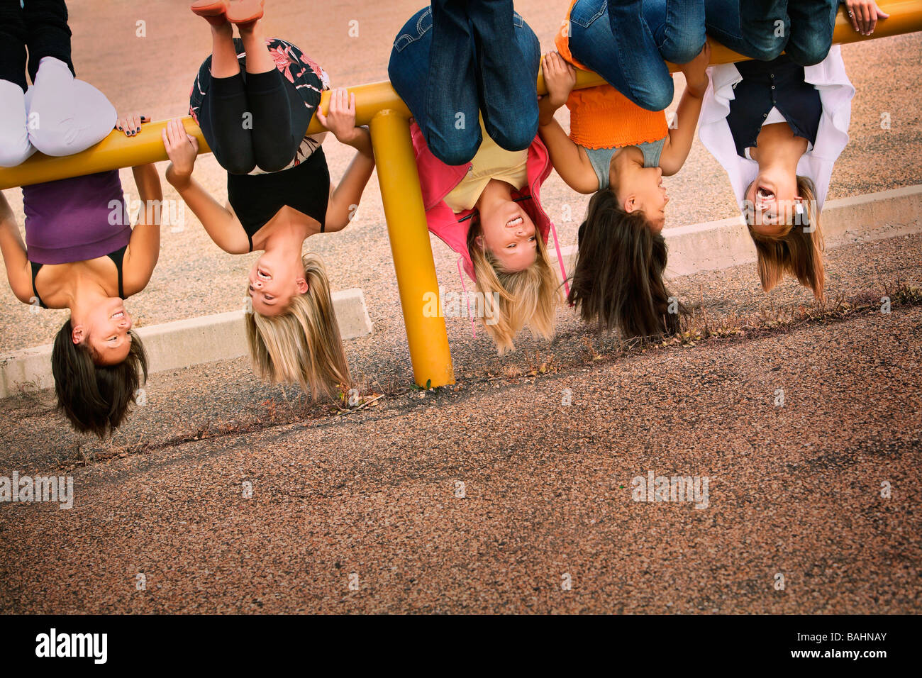 Girls hanging upside down Stock Photo - Alamy