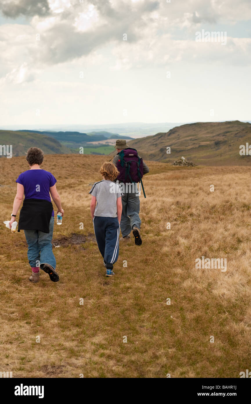 A family mother father and son walking along the Teifi Pools Walk ...