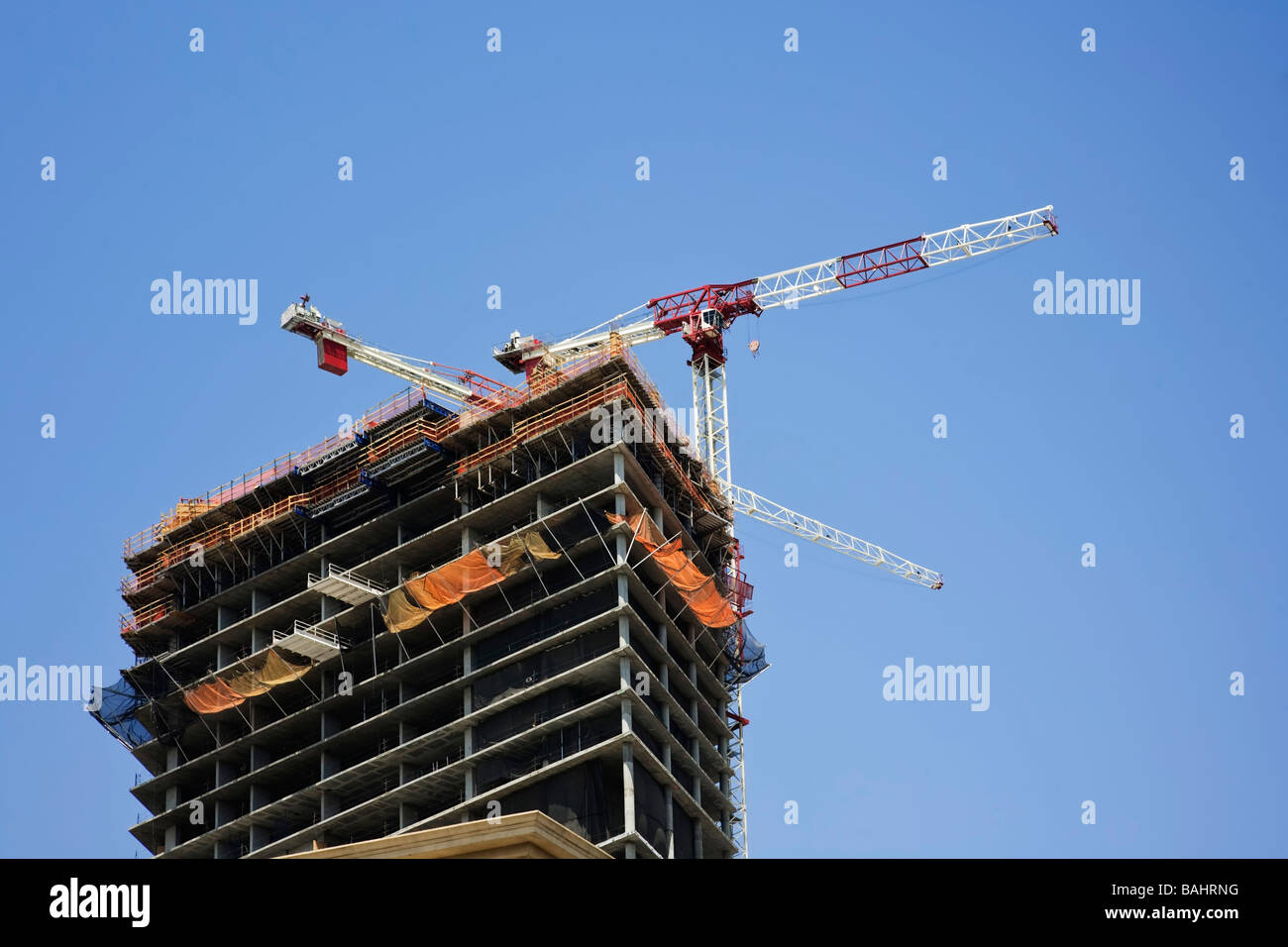 Construction cranes on the job site building a new skyscraper Stock ...