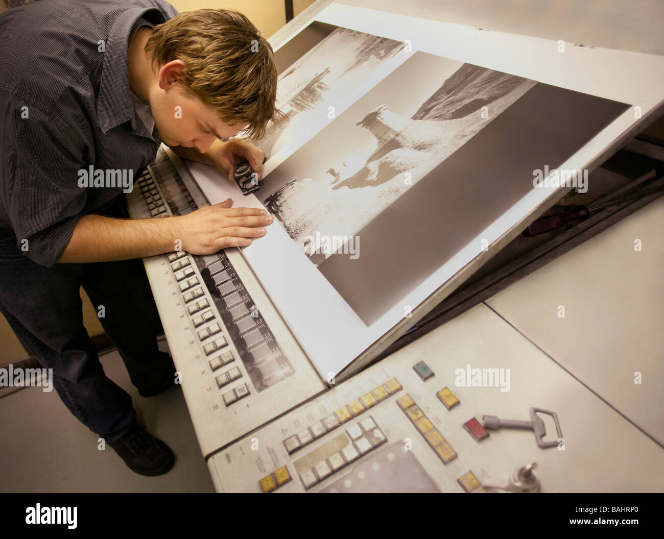 Man inspecting pictures Stock Photo - Alamy