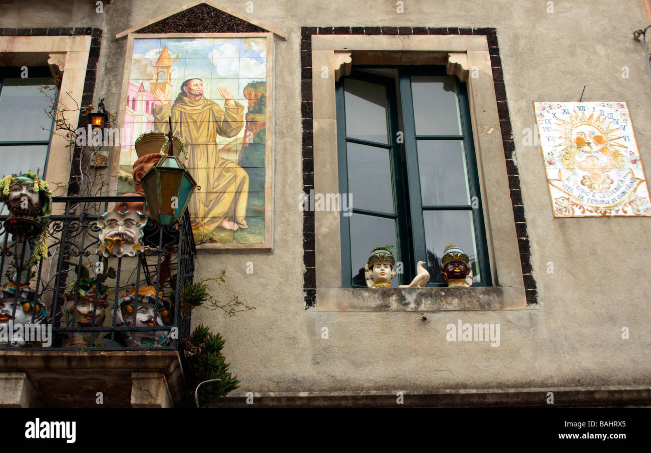 pictures in a walls of a house in taormina with balcony Stock Photo - Alamy