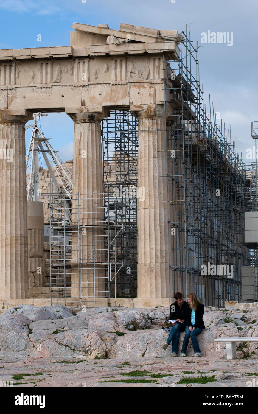 Tourists in front of Parthenon on Acropolis rock reading guide Stock ...