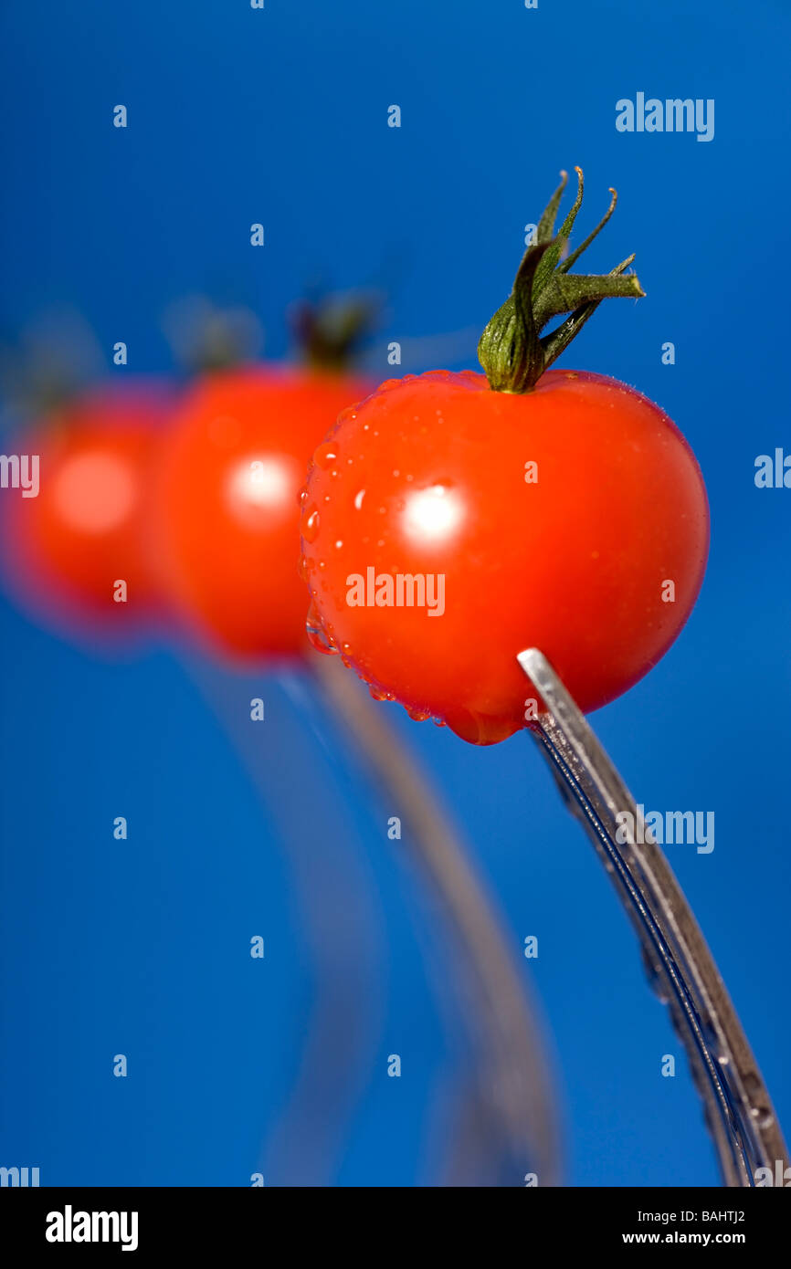 Three small cherry tomatoes hi-res stock photography and images - Alamy