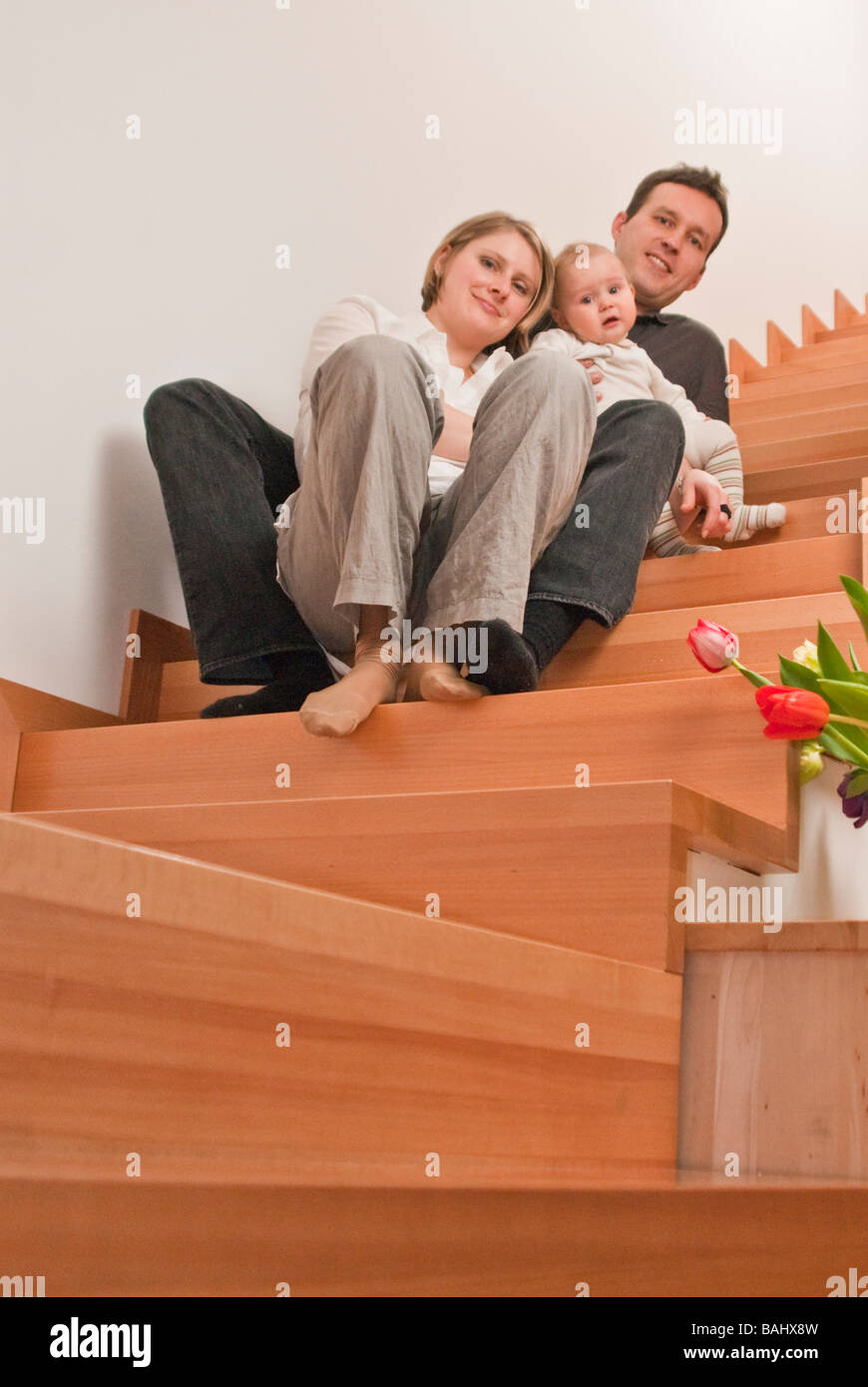 Family sitting on a staircase Stock Photo - Alamy