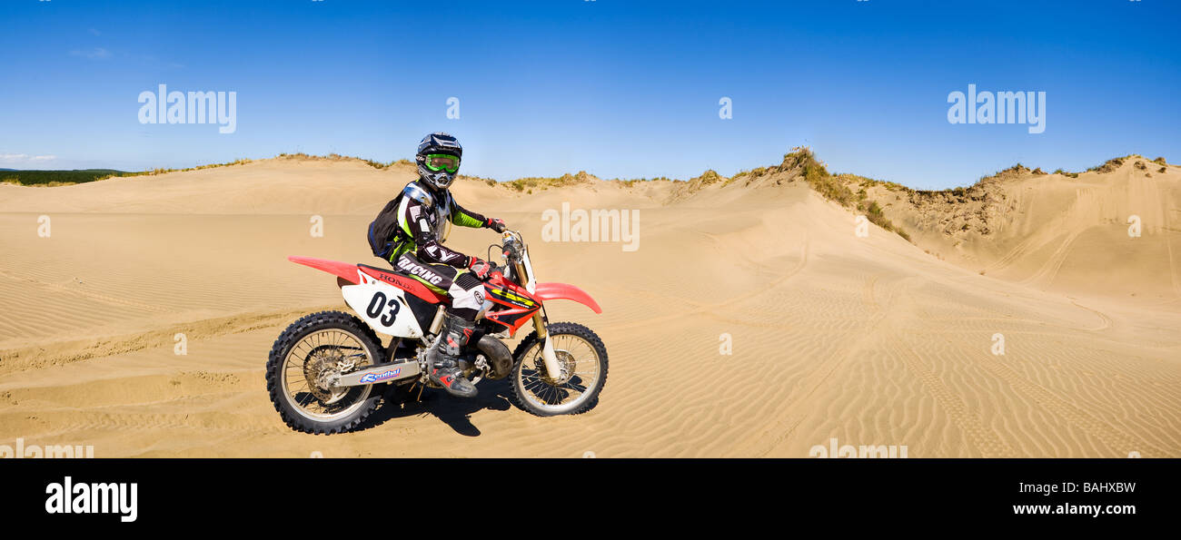 motorcyclist in sand dunes on dirtbike Stock Photo - Alamy