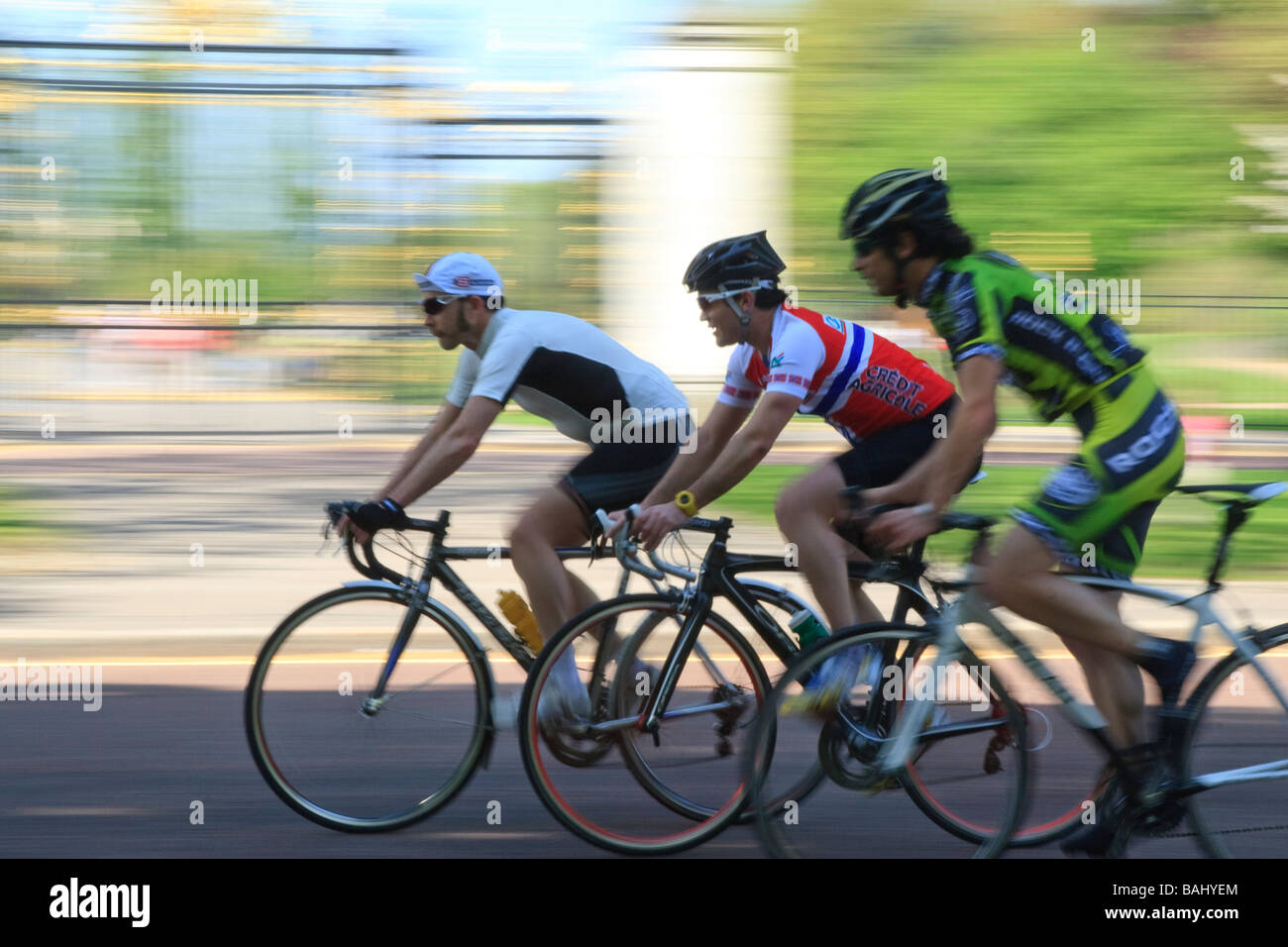 three cyclists on racing bikes doing training circuits on the Inner ...