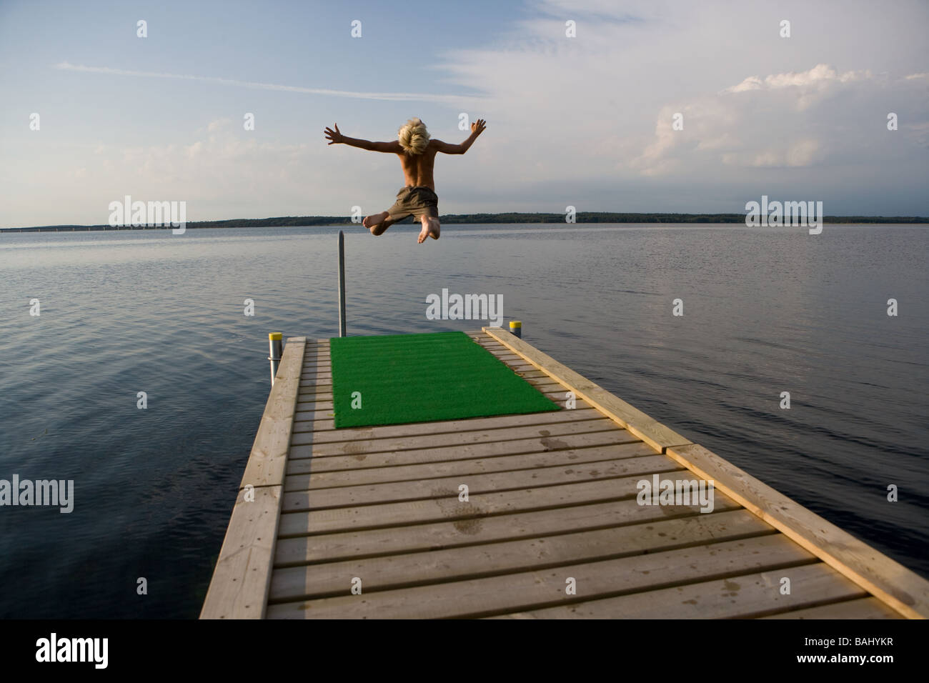 Child jumping off a pier hi-res stock photography and images - Alamy